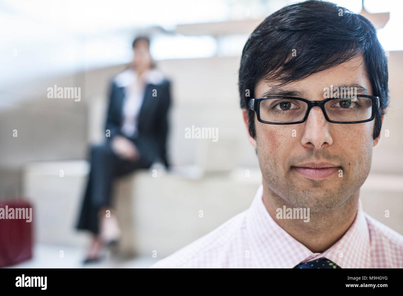 Hispanic business man in an office lobby Stock Photo - Alamy