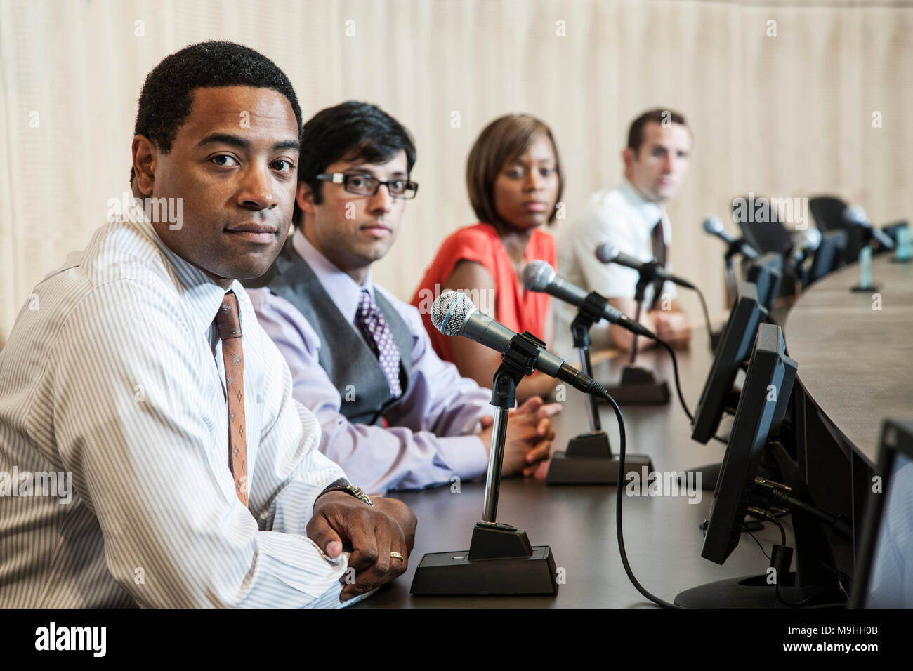 A group of men and a woman, an ethnically diverse panel of politicians ...