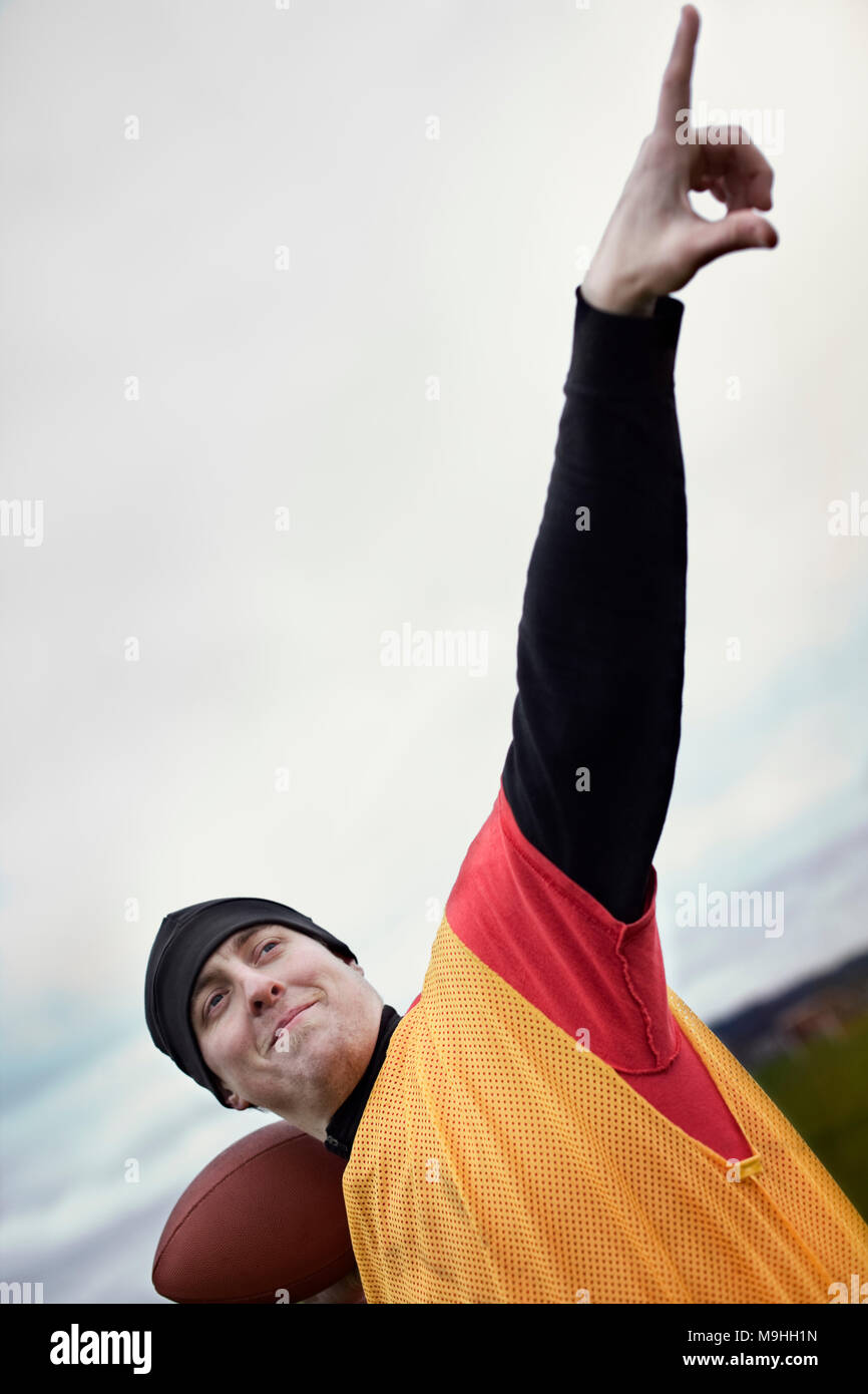View of a quarterback leaning back and preparing to throw a football ...