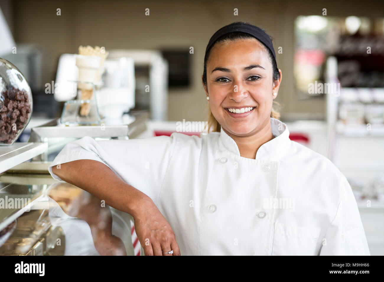 Portrait of Hispanic woman owner of a candy shop Stock Photo - Alamy