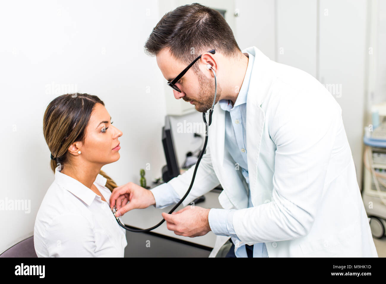 Woman and doctors and checkup hi-res stock photography and images - Alamy