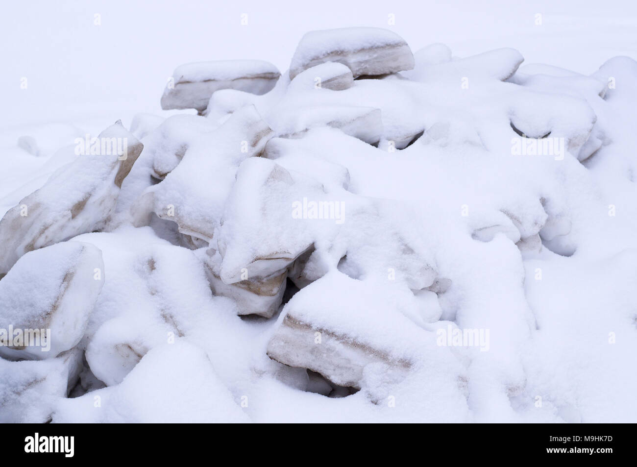 pile of melting ice blocks cowered with snow. seasonal, background ...