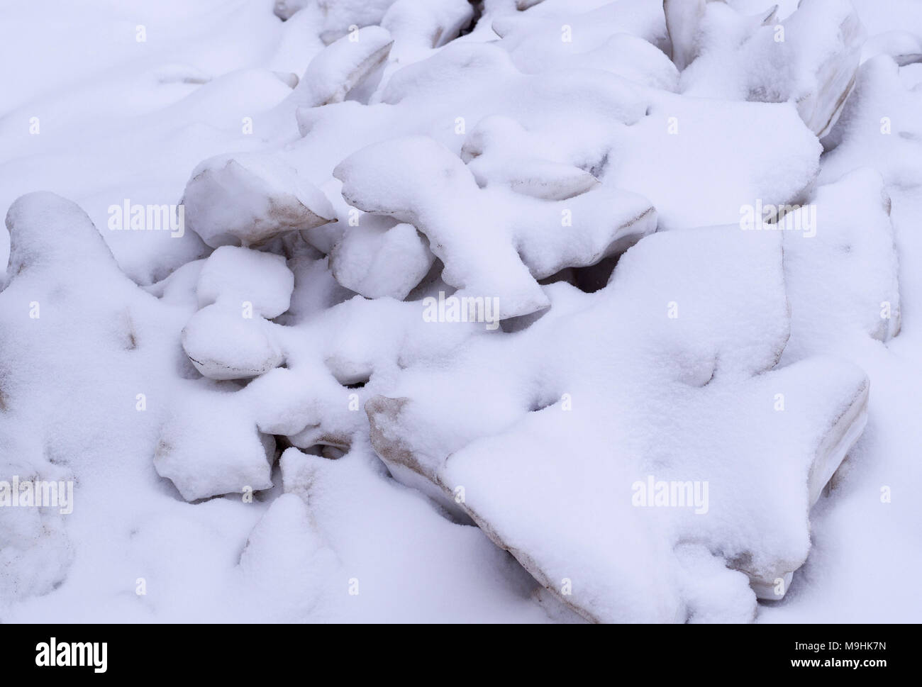pile of melting ice blocks cowered with snow. seasonal, background ...