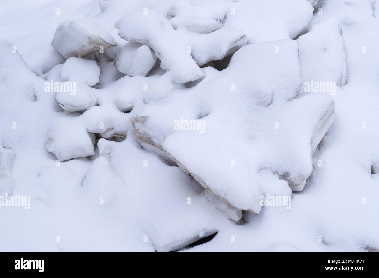 pile of melting ice blocks cowered with snow. seasonal, background ...