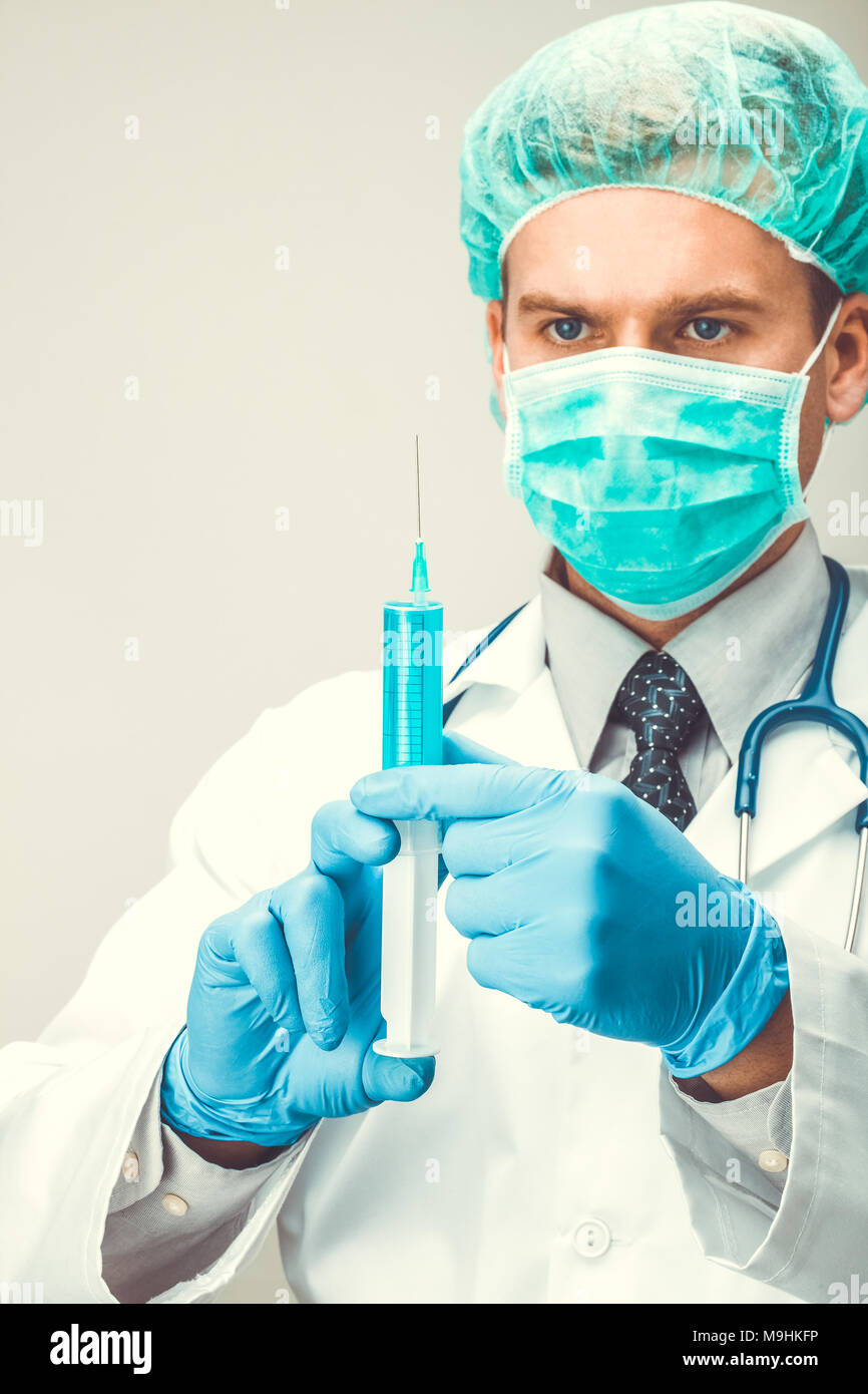 Medical doctor with syringe in hands preparing for making injection ...