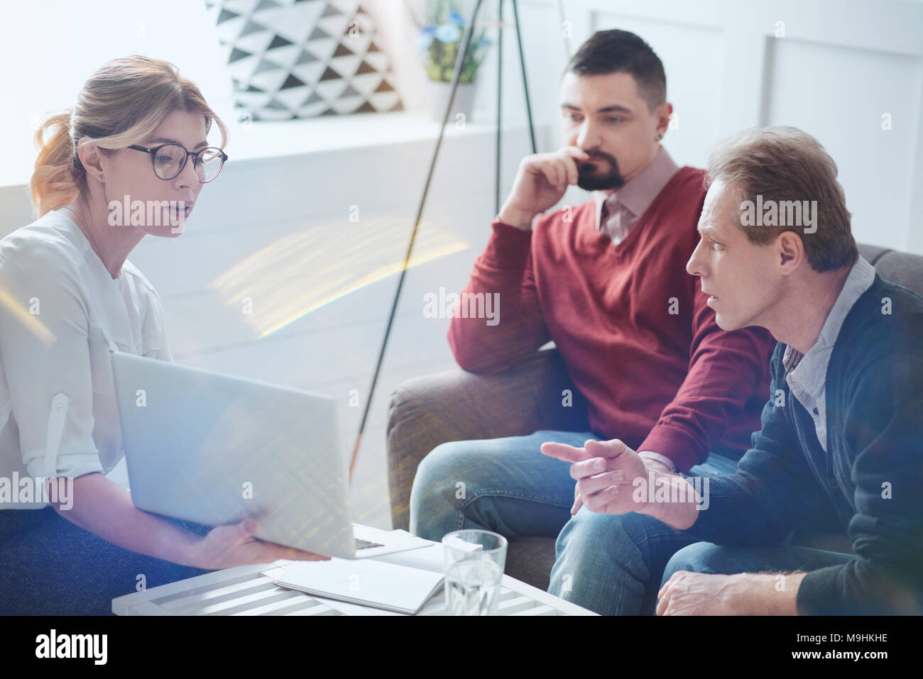 Nice pleasant colleagues talking about work Stock Photo - Alamy
