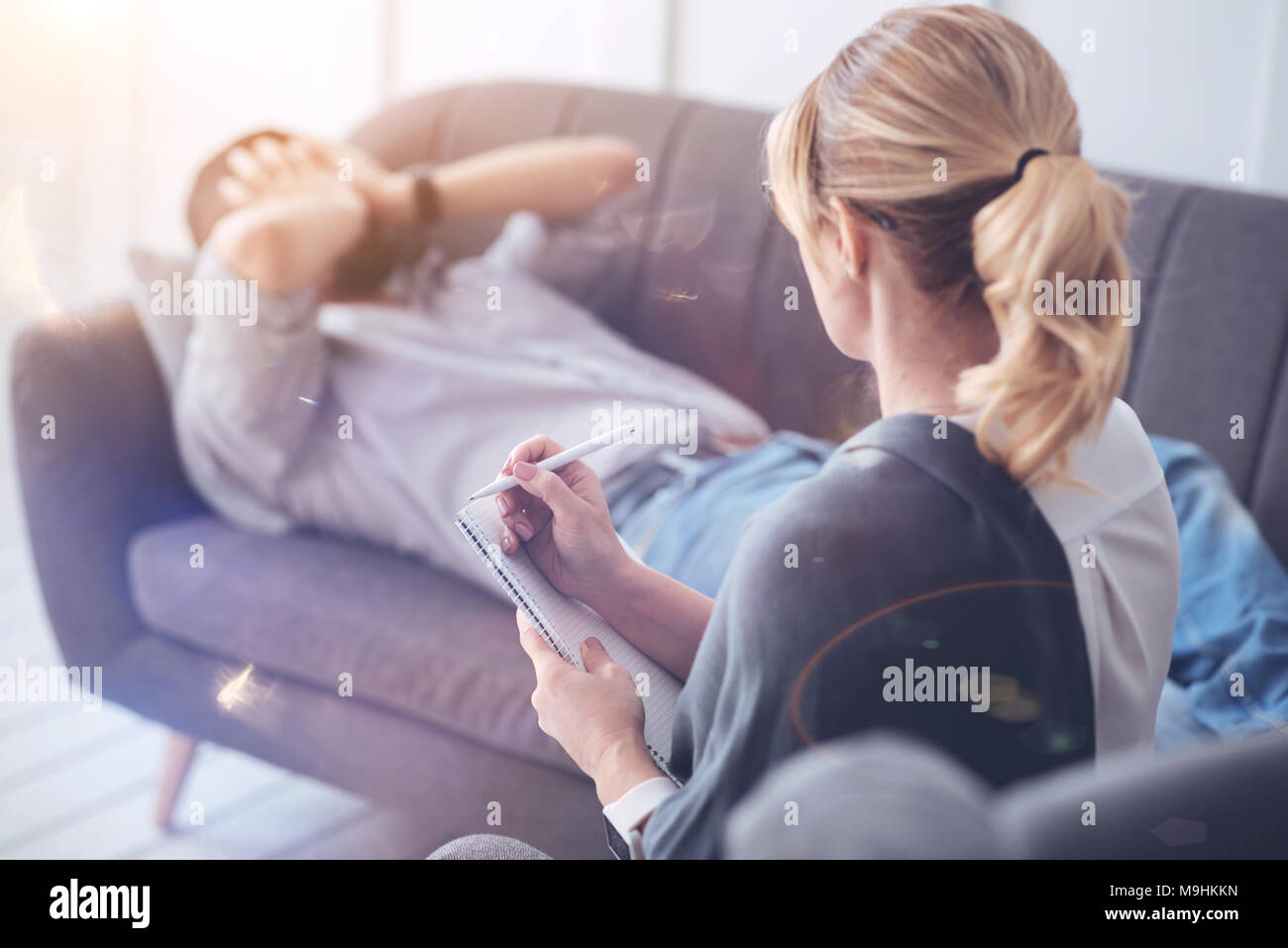 Serious thoughtful psychologist being ready to take notes Stock Photo ...