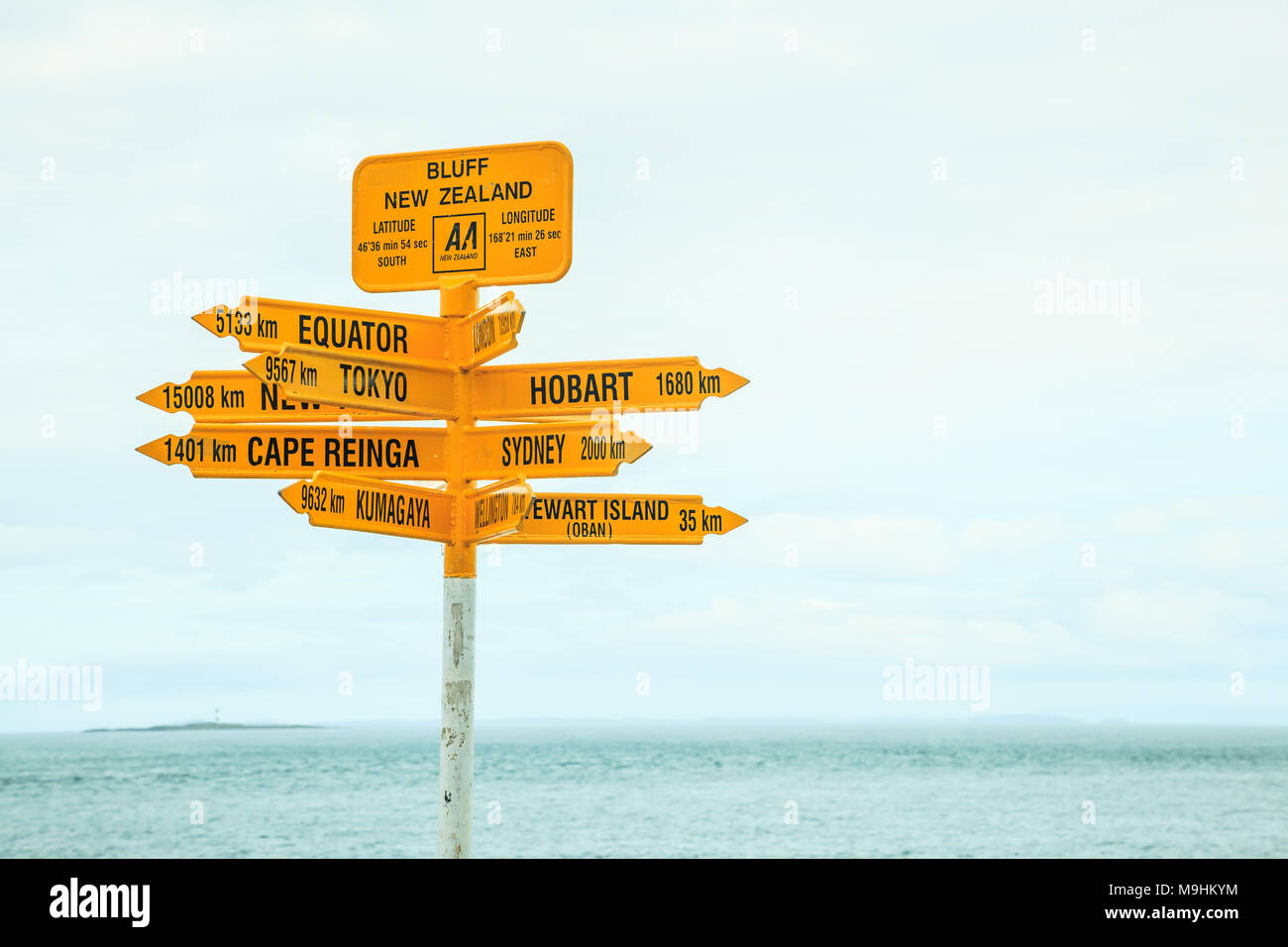 Bluff New Zealand yellow Signpost, with arrows pointing to different ...