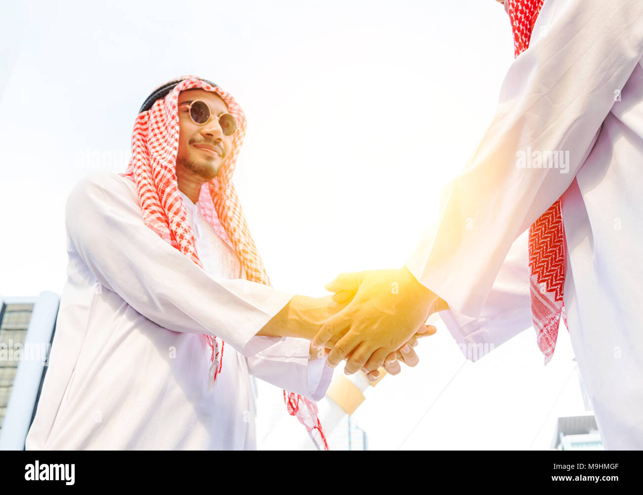 Successful Arab saudi emirates businessman shaking hands over a deal ...