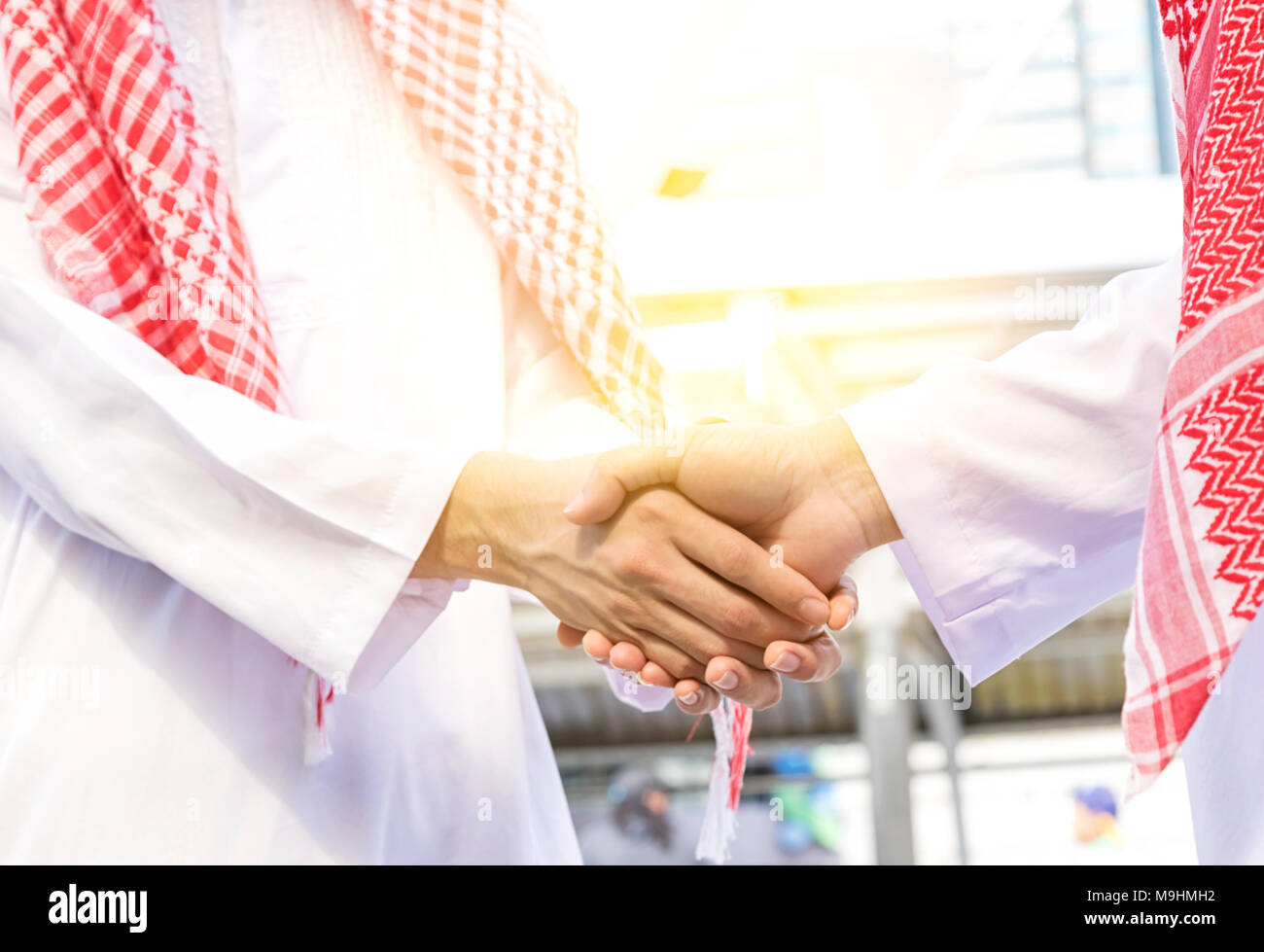 Successful Arab saudi emirates businessman shaking hands over a deal ...