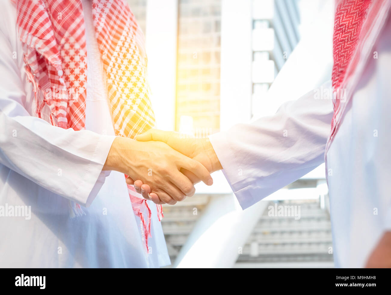 Successful Arab saudi emirates businessman shaking hands over a deal ...