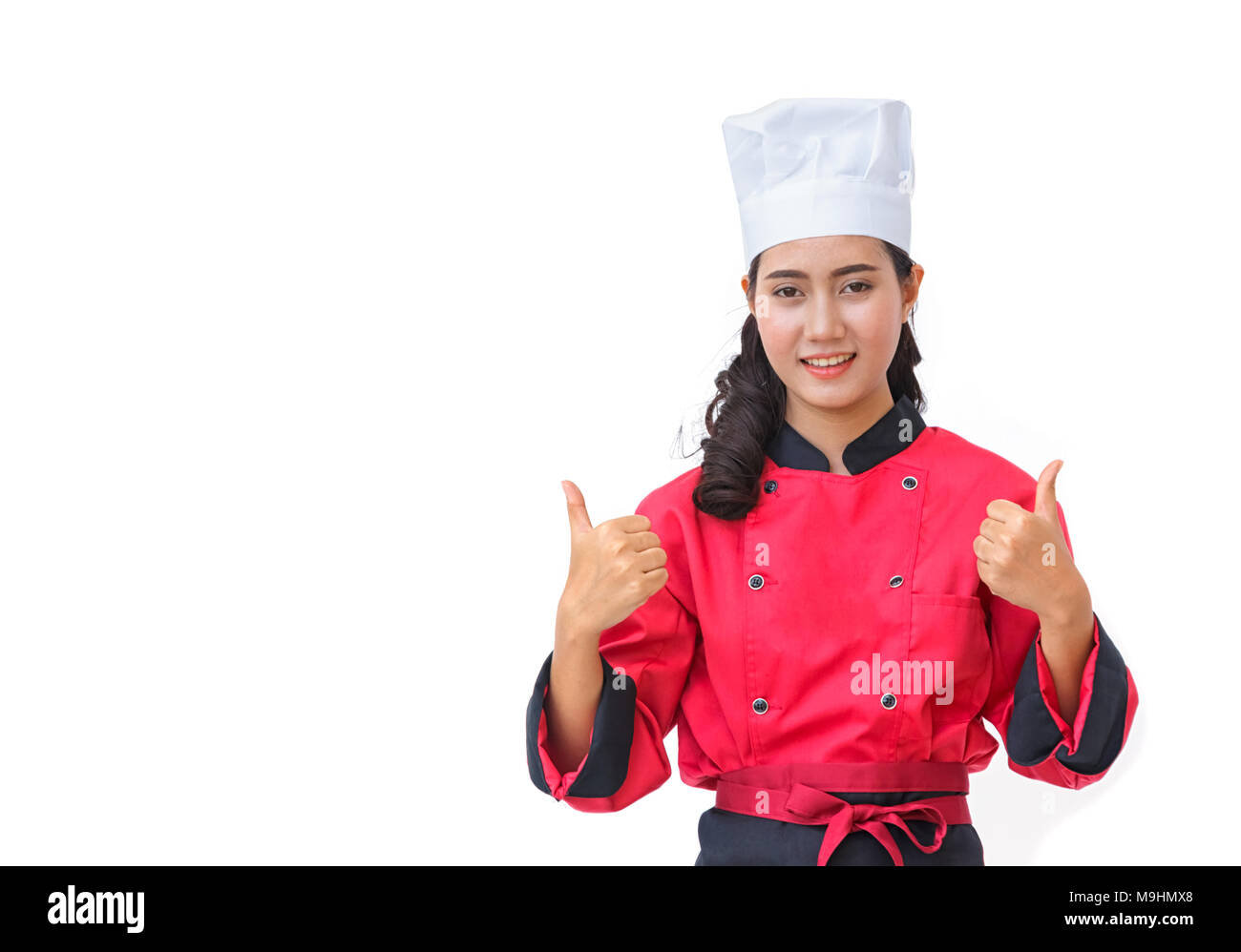 Smiling chef woman in red uniform showing thumbs up gesture isolated on ...