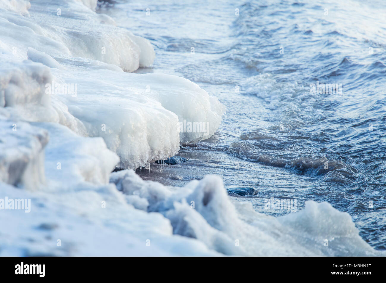 A beautiful frozen salt water on the beach of Baltic sea. Ice ...