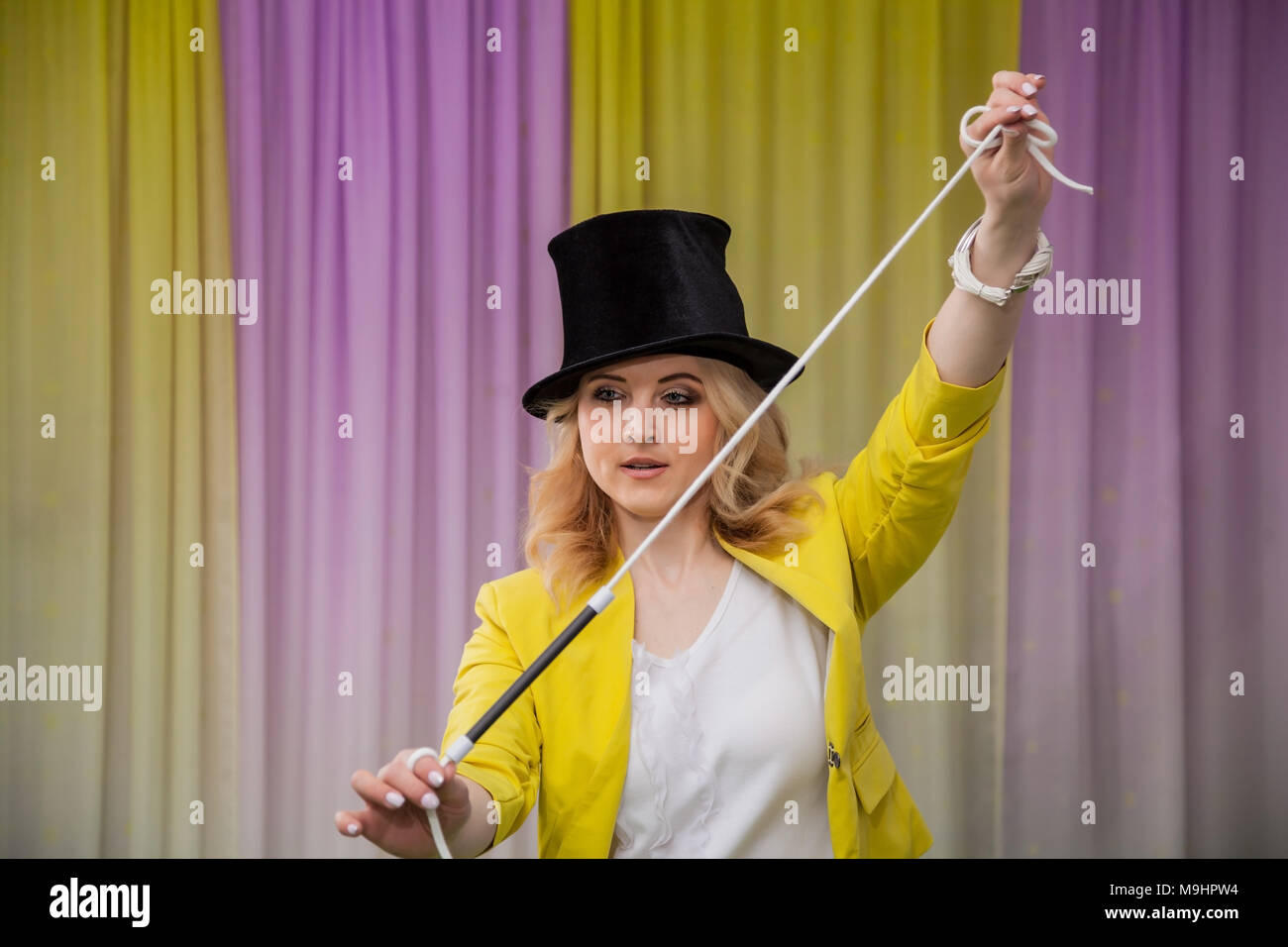 Woman magician shows tricks Stock Photo - Alamy