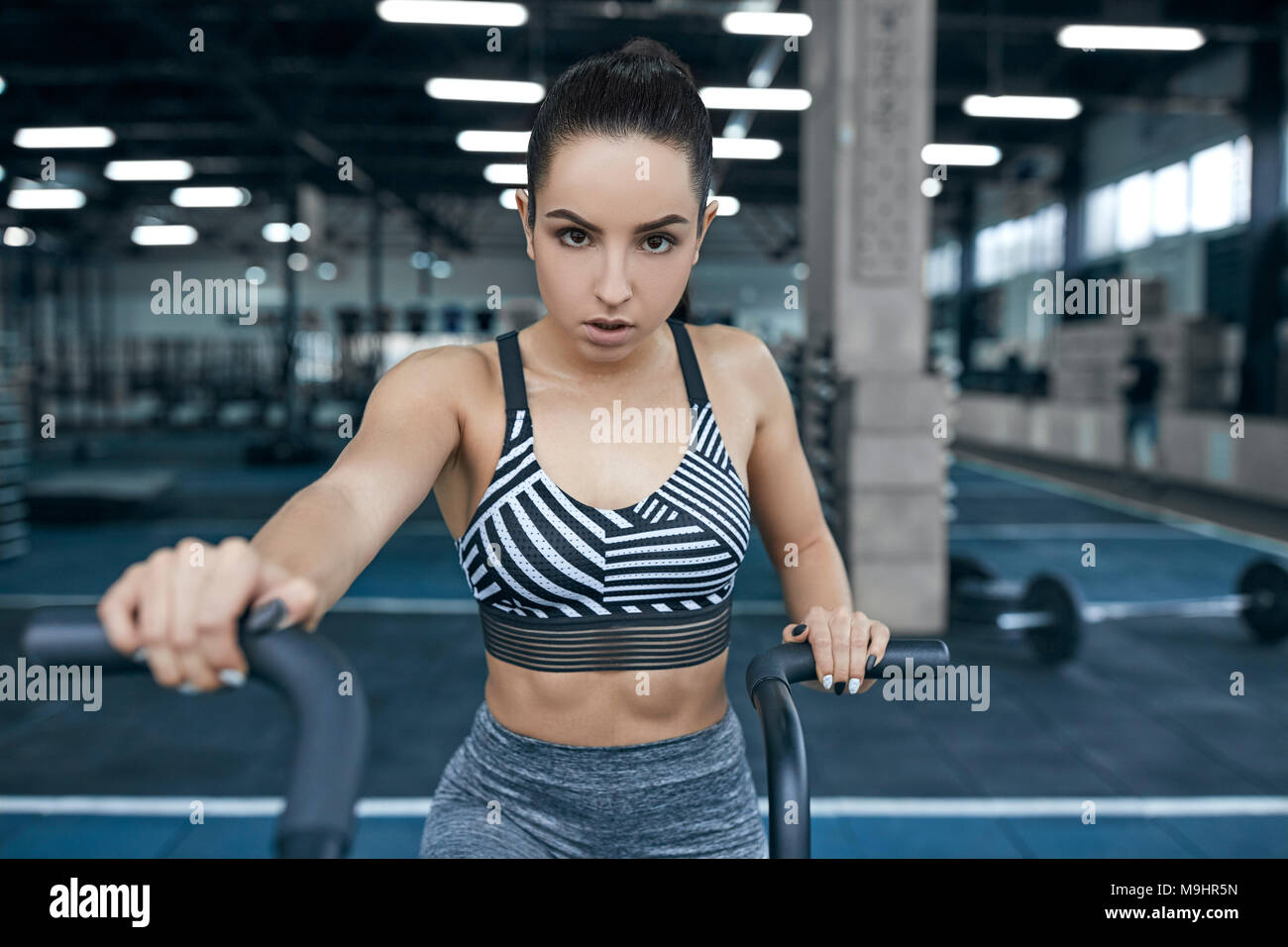 Young woman exercises in gym healthy lifestyle holding barbell Stock ...
