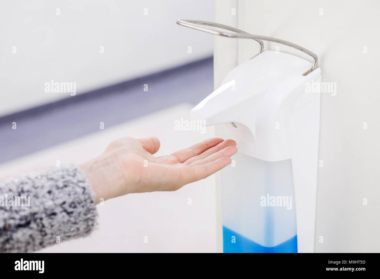 Hands desinfection dispenser in medical center. Antibacterial procedure ...