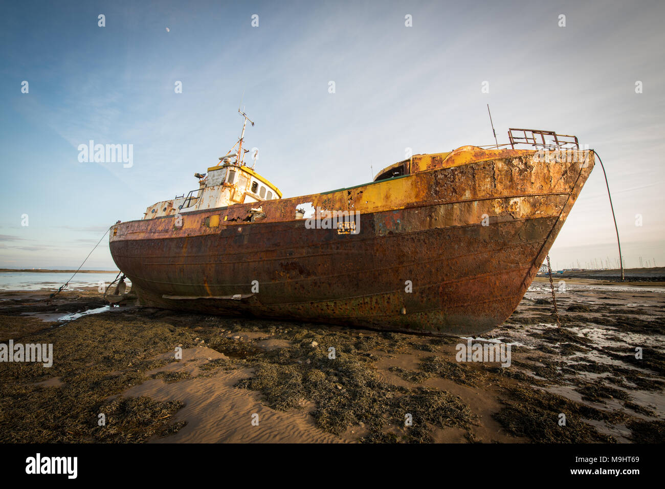 An old beached trawler slowly rusting on the beach at Rampside near ...