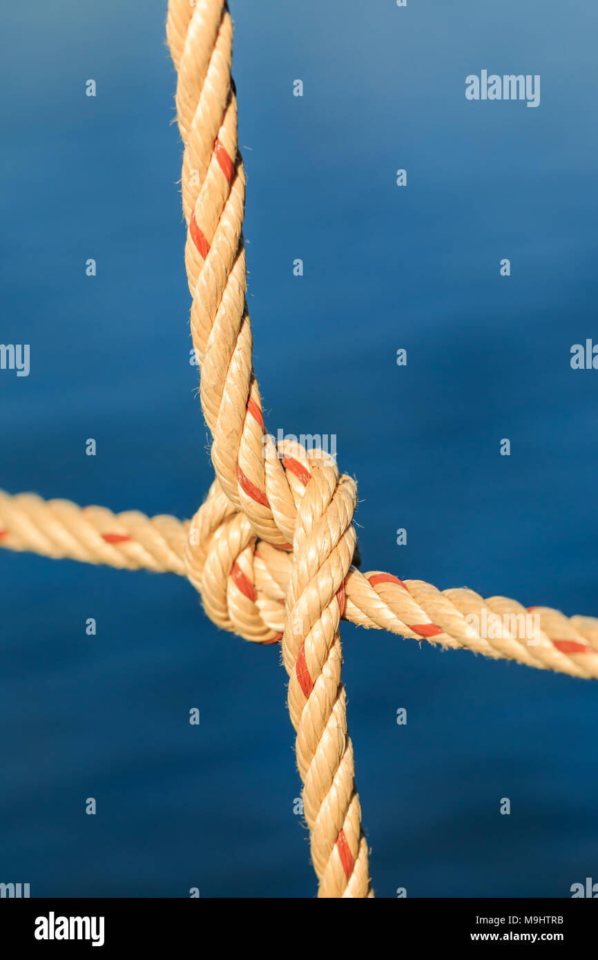 Old fishing boat rope with a Tied Knot Stock Photo - Alamy