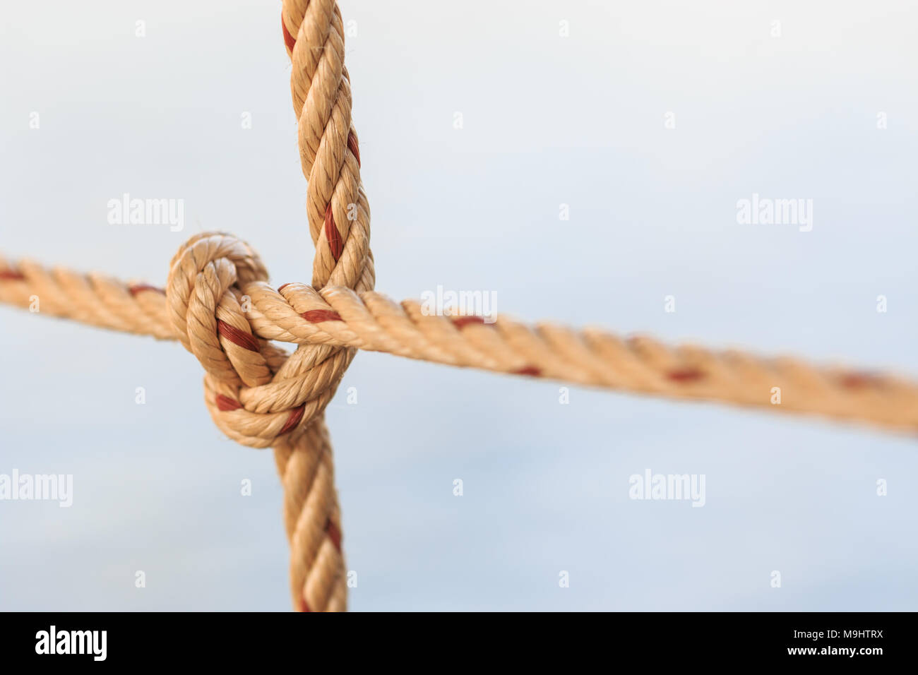 Old fishing boat rope with a Tied Knot Stock Photo - Alamy
