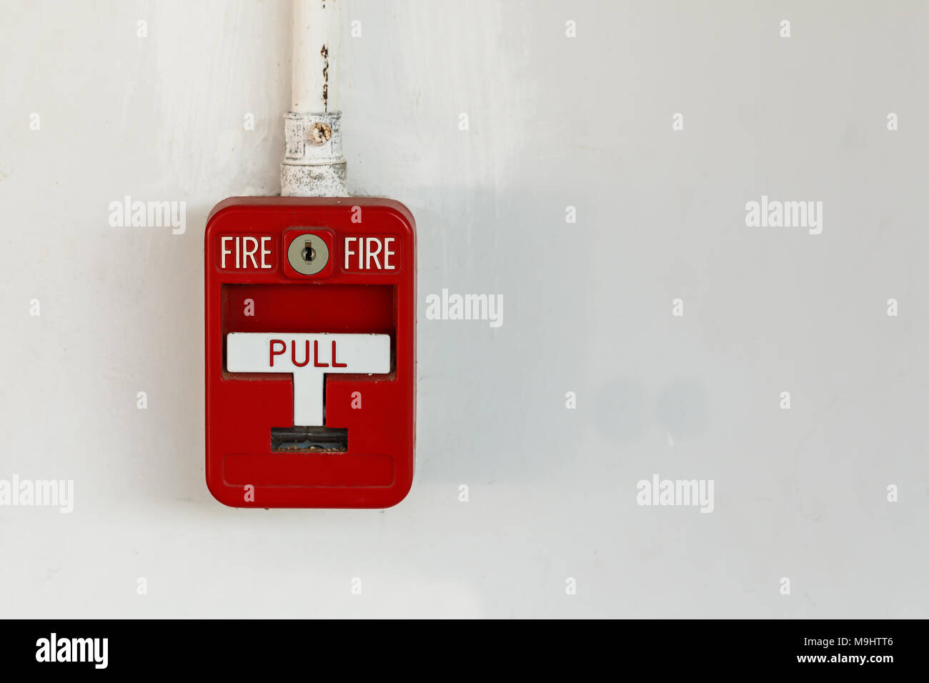 Old red box fire alarm isolated on white background Stock Photo - Alamy