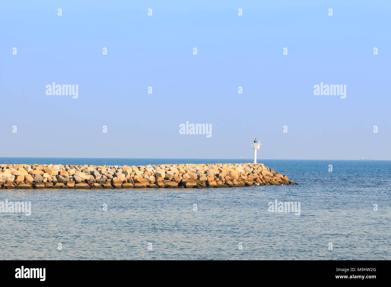 breakwater in the sea with beacon light on it Stock Photo - Alamy