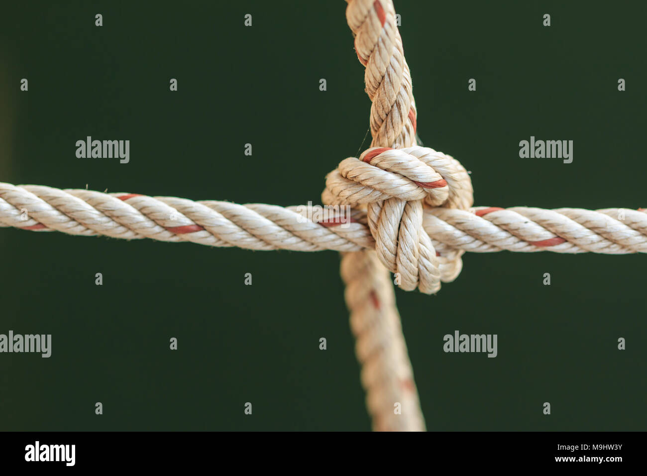 Old fishing boat rope with a Tied Knot Stock Photo - Alamy