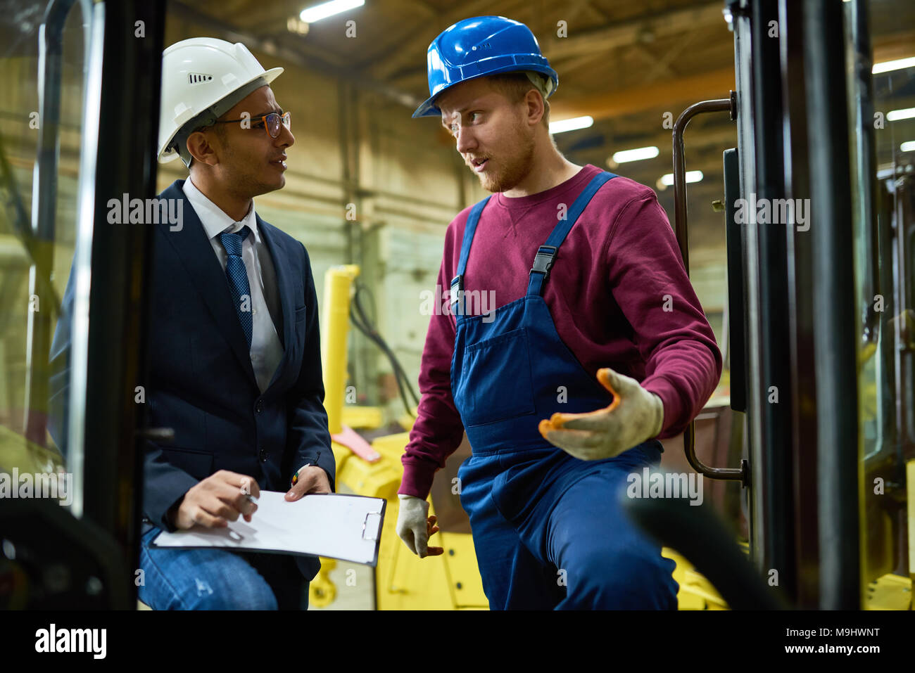 Truck Driver Talking to Businessman Stock Photo - Alamy