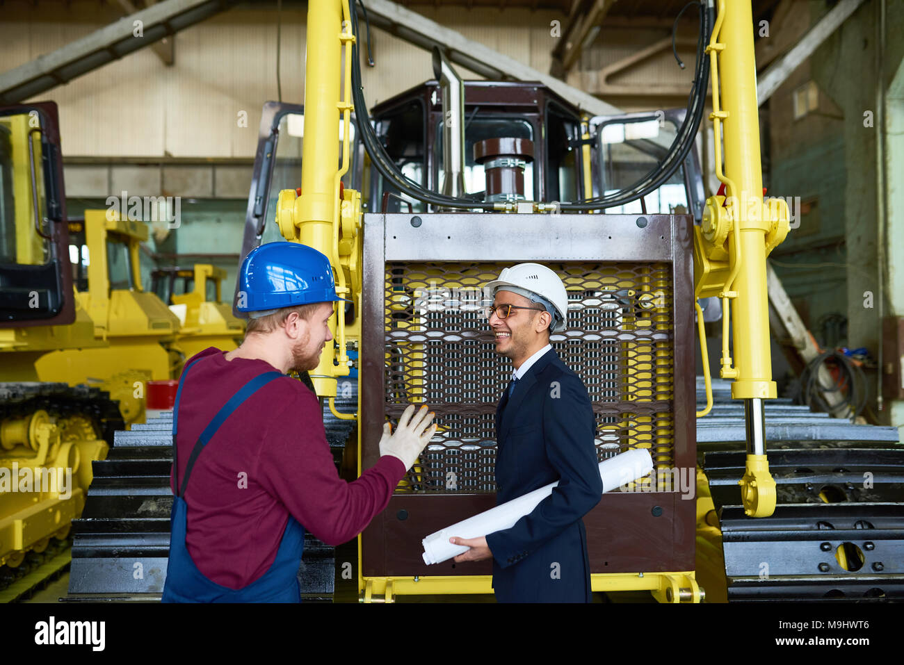 Engineer Talking to Tractor Driver Stock Photo - Alamy