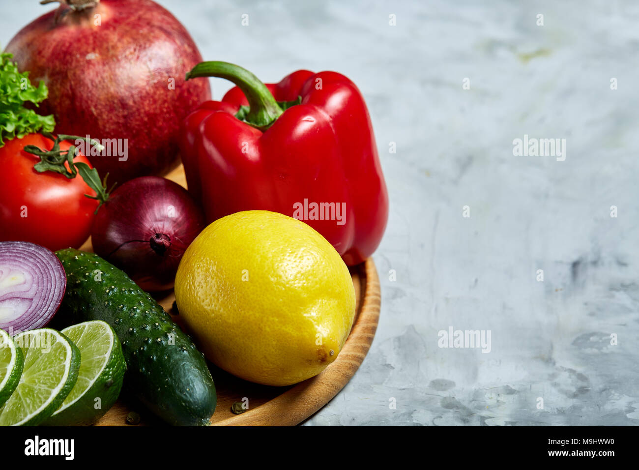 Ripe fresh fruits in a wooden plate on a light background, selective ...