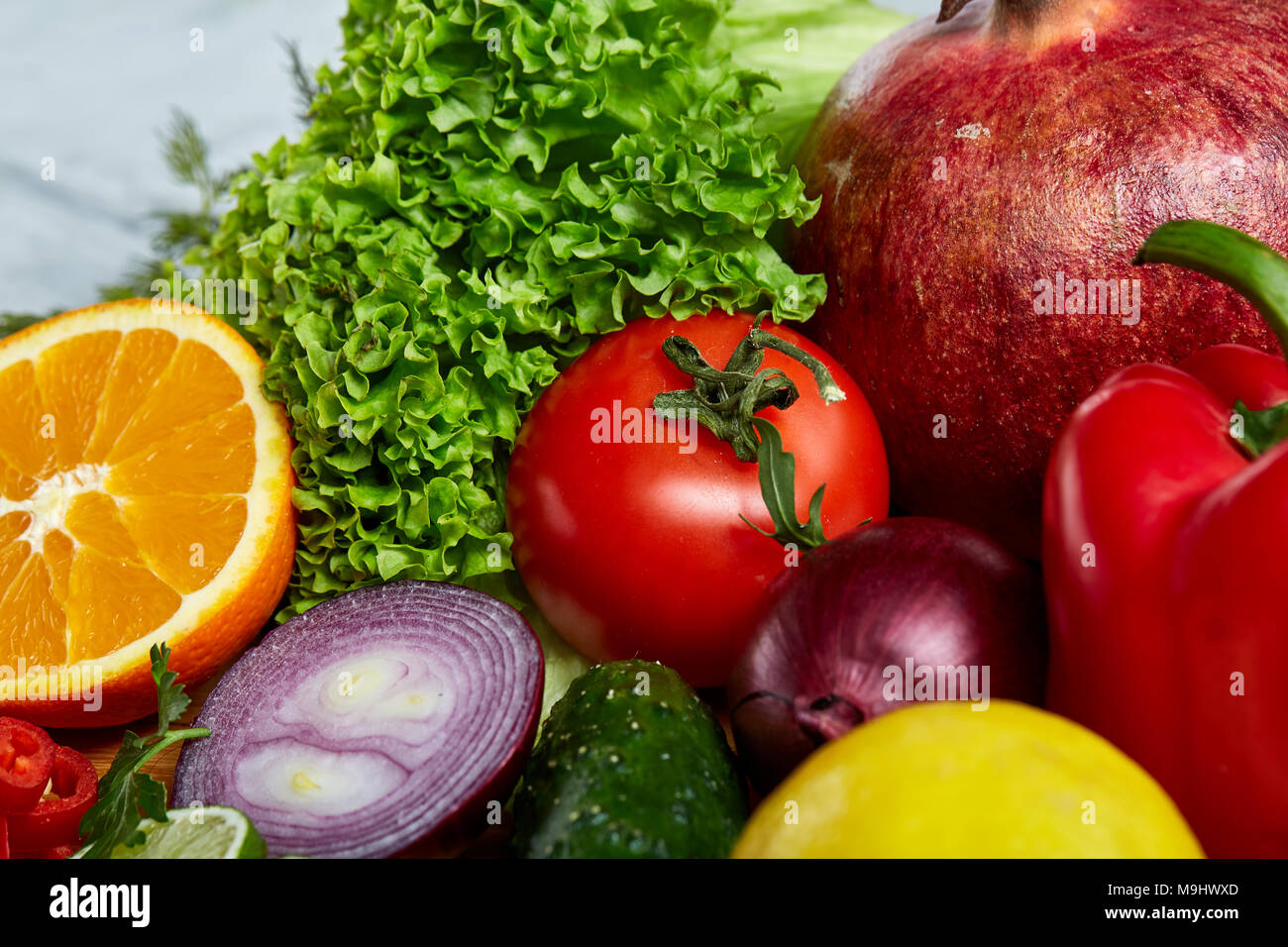 Ripe fresh fruits in a wooden plate on a light background, selective ...
