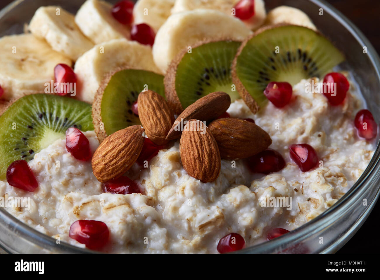 Delicious oatmeal porrige with kiwi, banana, pomergranate seeds and ...
