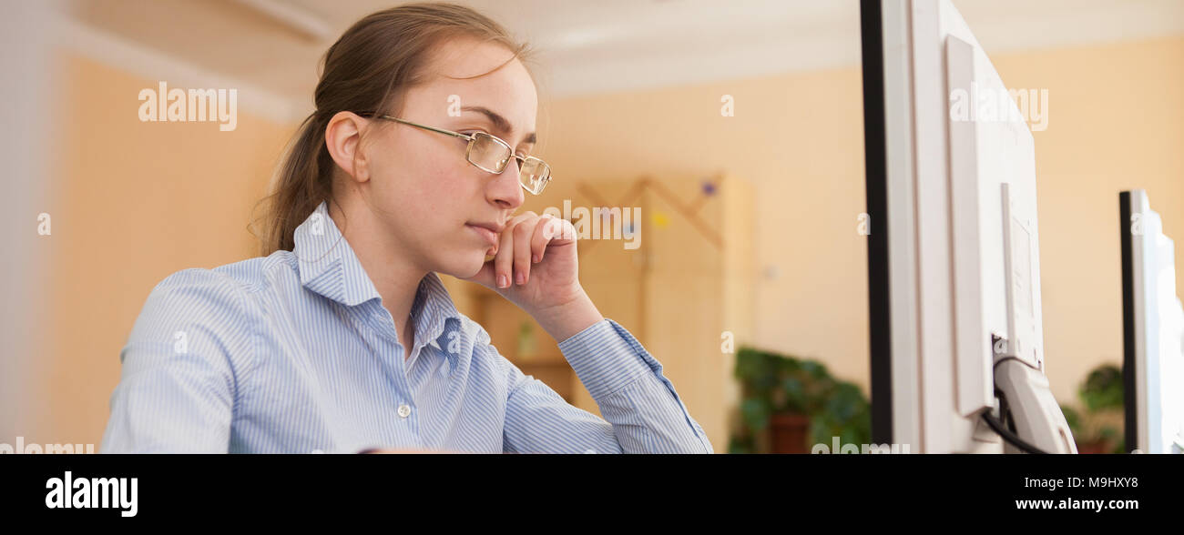 Concentrated businesswoman trying to solve a difficult assignment on ...