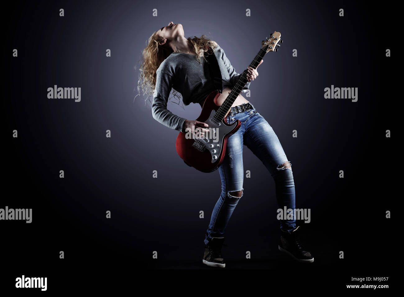 Young and beautiful rock girl playing the electric guitar Stock Photo ...