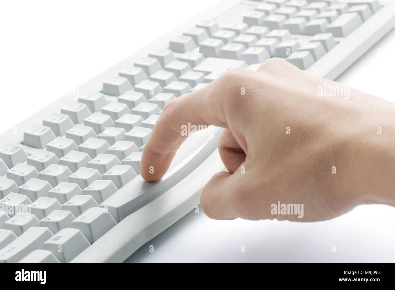 finger hit the button on the old computer keyboard Stock Photo - Alamy