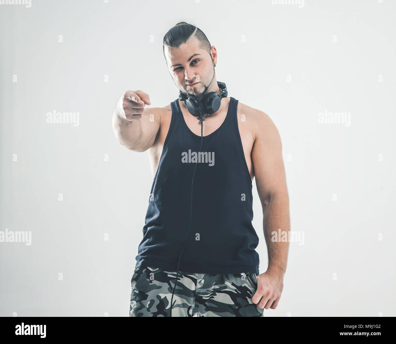 emotional and charismatic DJ - rapper with headphones on a white Stock ...