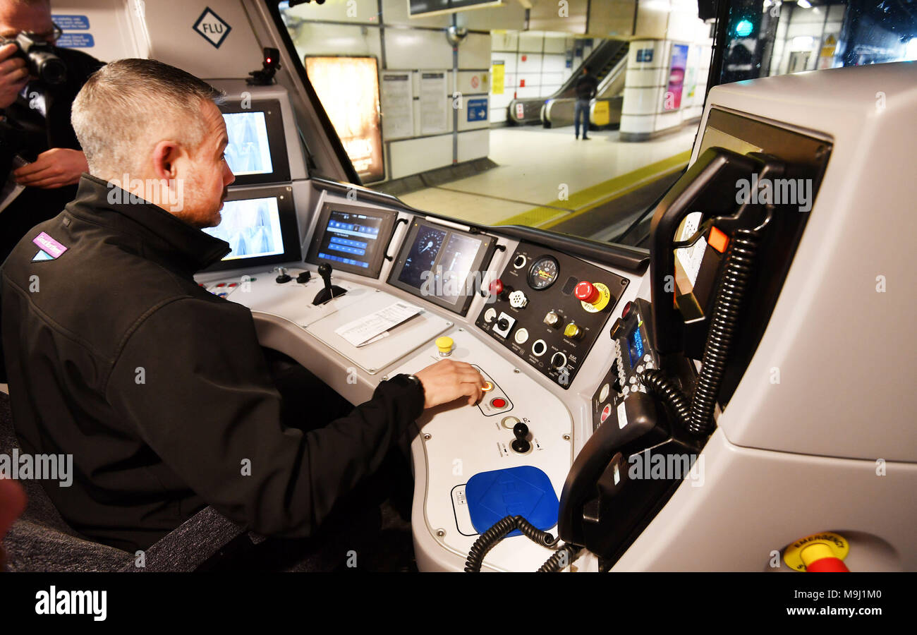 A driver presses the ATO (Automatic Train Operation) button on a train ...