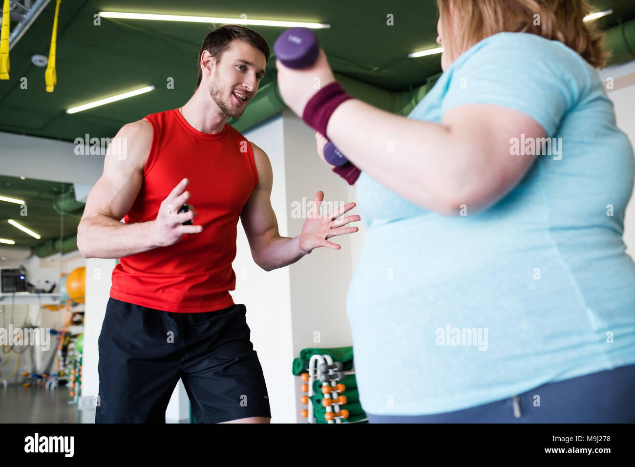 Personal Trainer Working with Client Stock Photo - Alamy