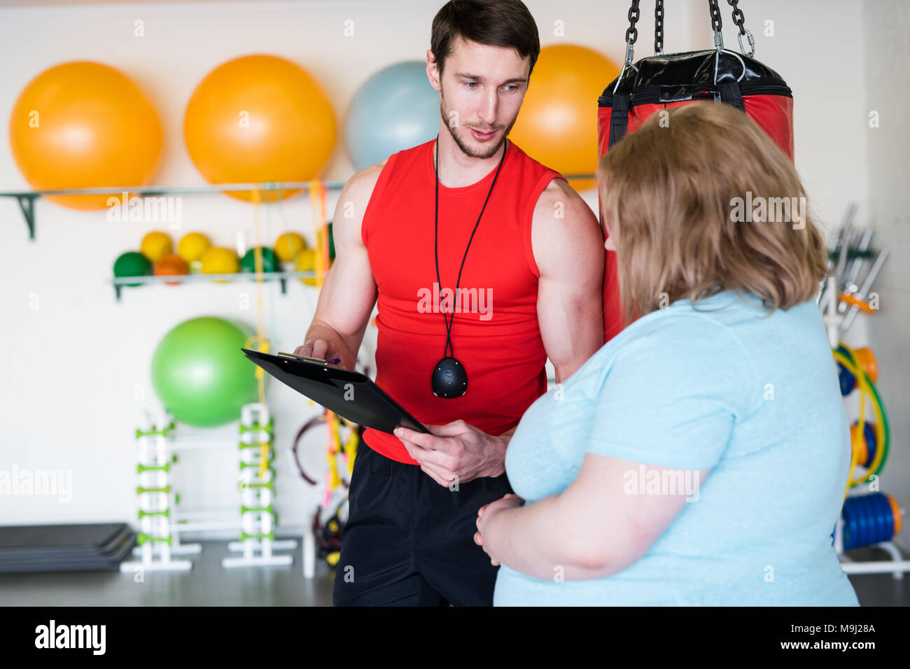 Personal Trainer Talking to Client Stock Photo - Alamy
