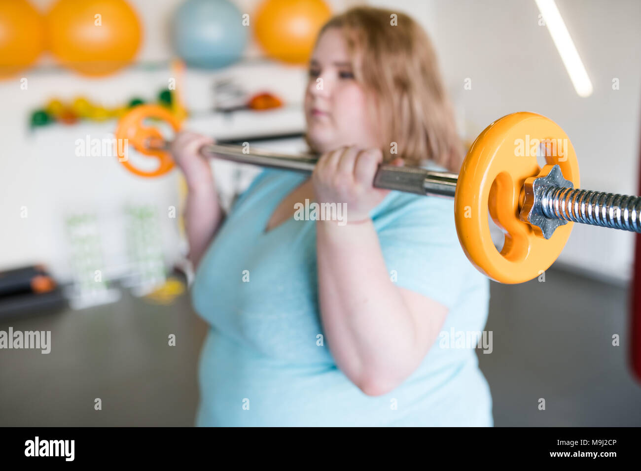 Obese Woman Working Out with Barbell Stock Photo - Alamy