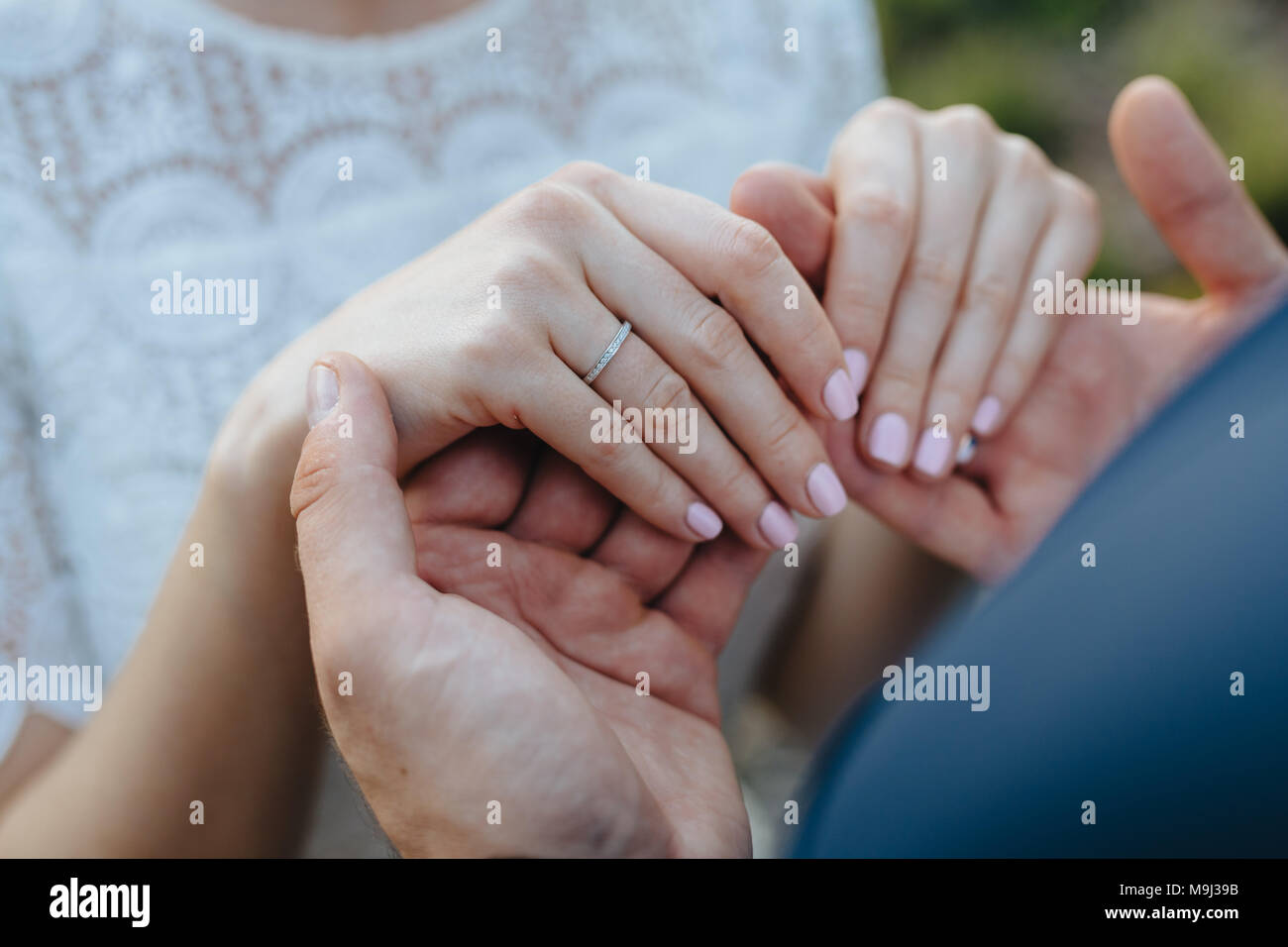 Lovers holding hands with gold wedding rings. Wedding Stock Photo - Alamy