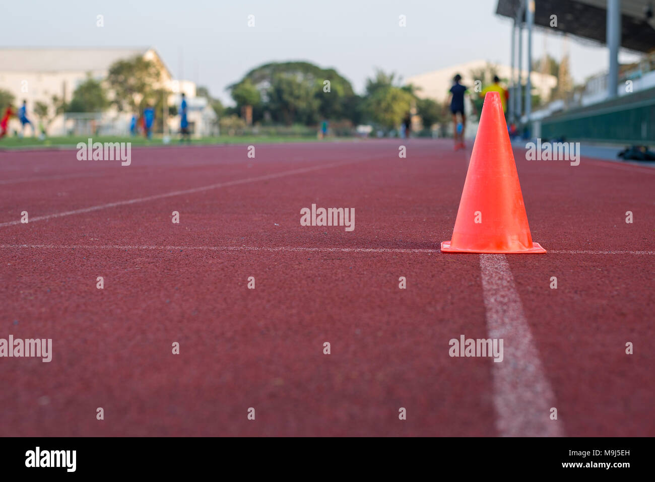 Orange cone on racetrack used in practice run Stock Photo - Alamy