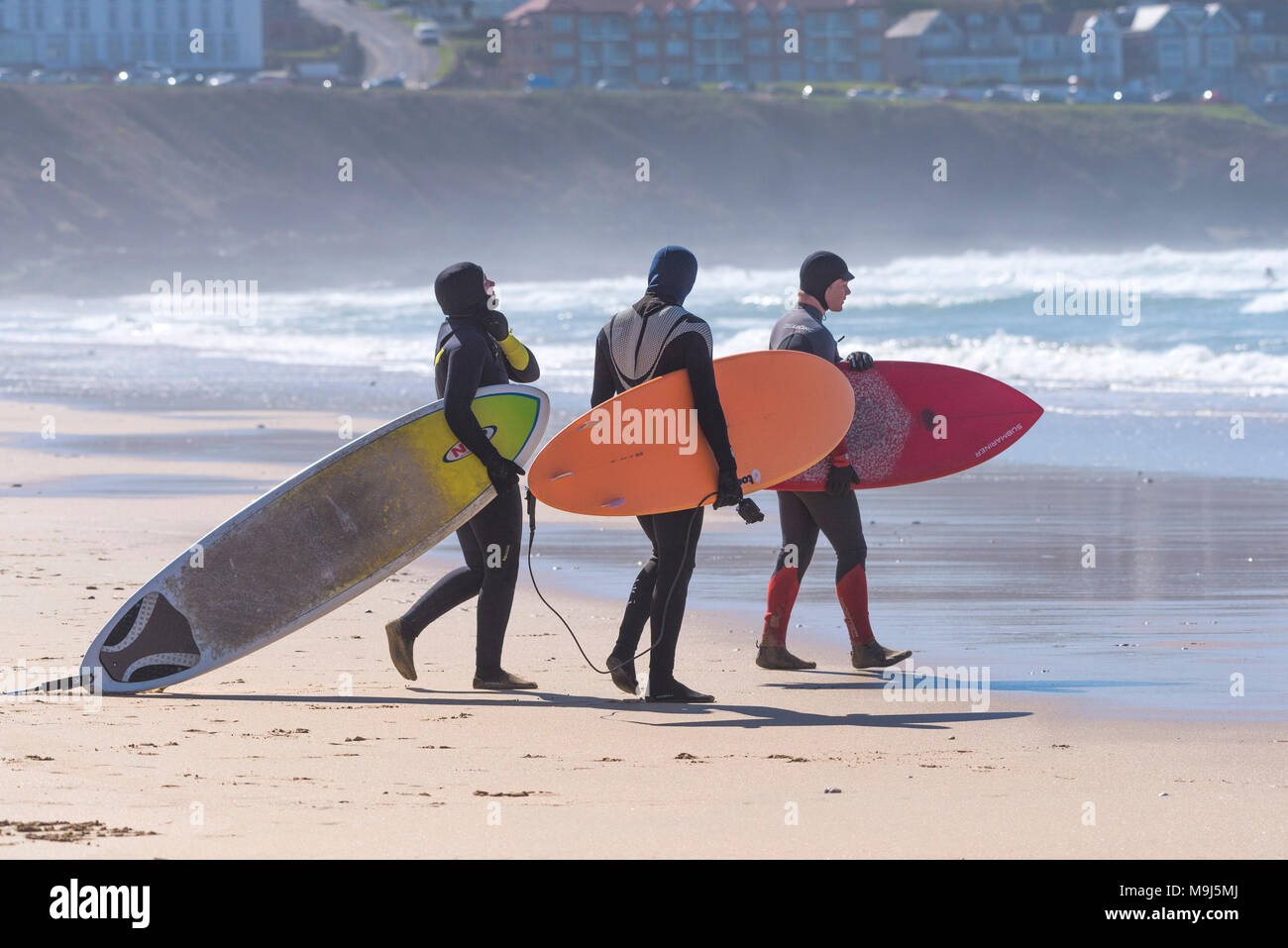 UK surfing - surfers carrying their surboards across Fistral beach in ...