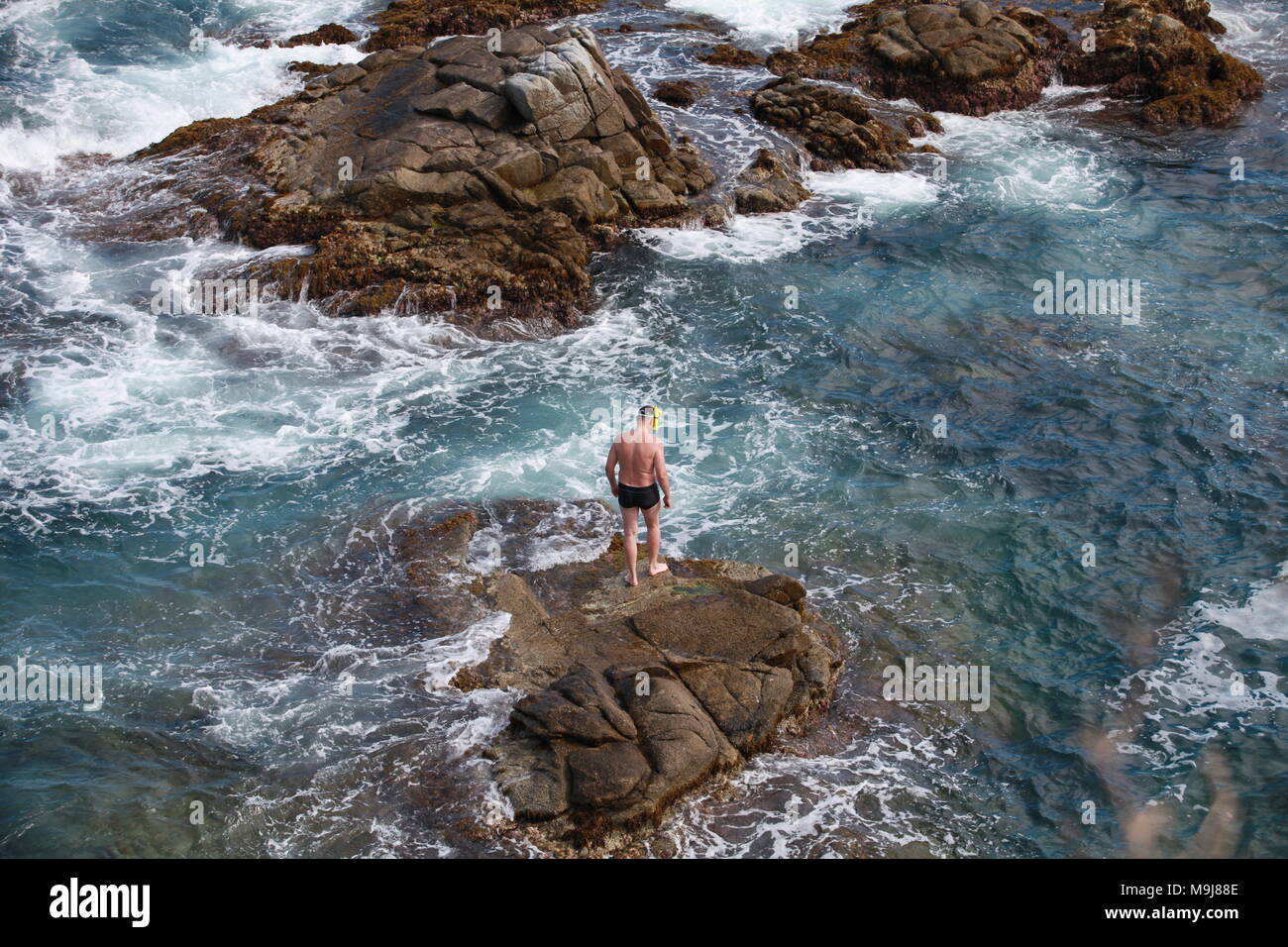 Man jumping rock coast hi-res stock photography and images - Alamy