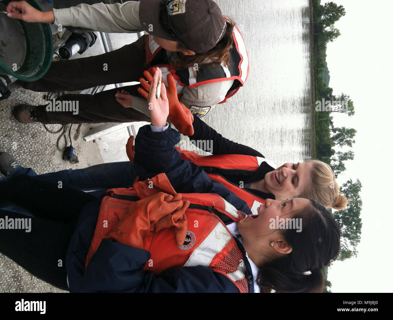 A first time holding a minnow caught from seining the river. USFWS ...