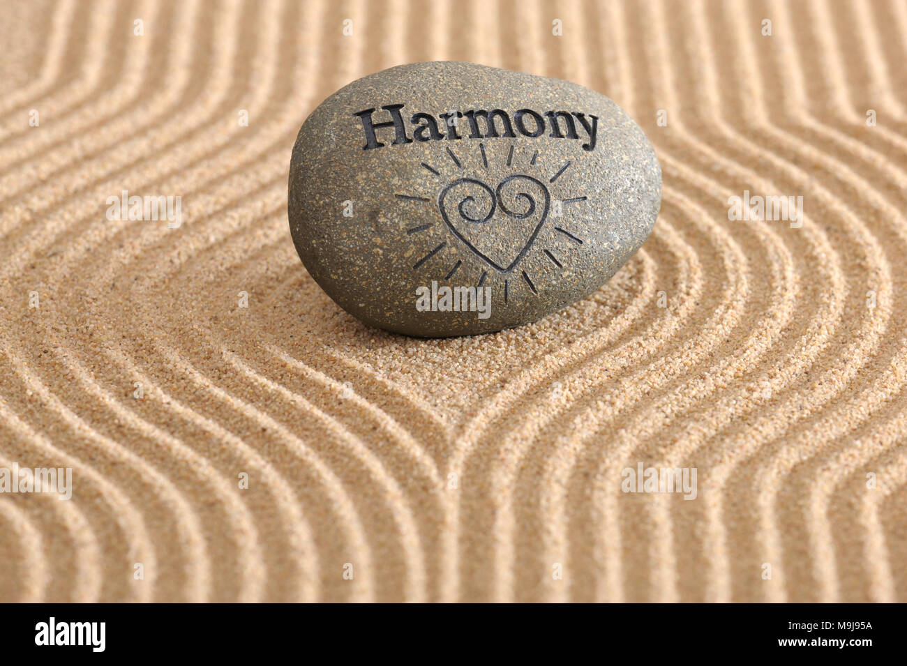 Japanese Zen garden with stone of harmony in textured sand Stock Photo ...