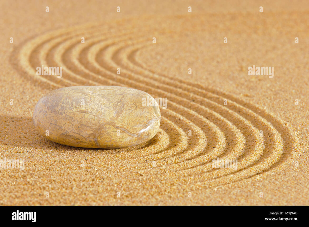 Japanese Zen garden with stone in textured sand Stock Photo - Alamy