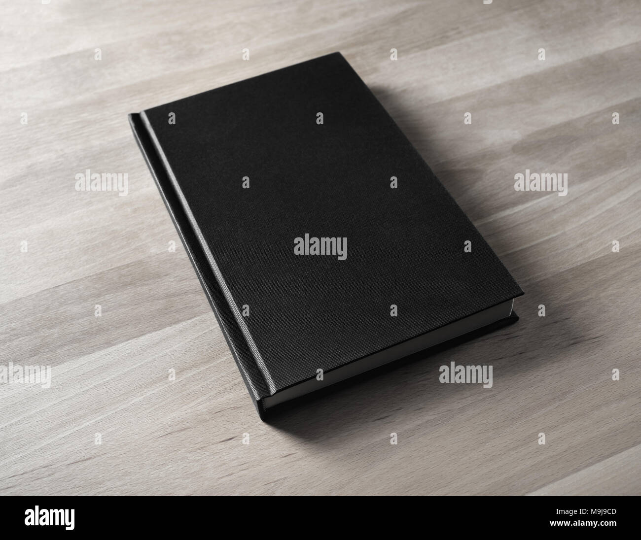 Blank black cover book on wood table background. Template for placing ...