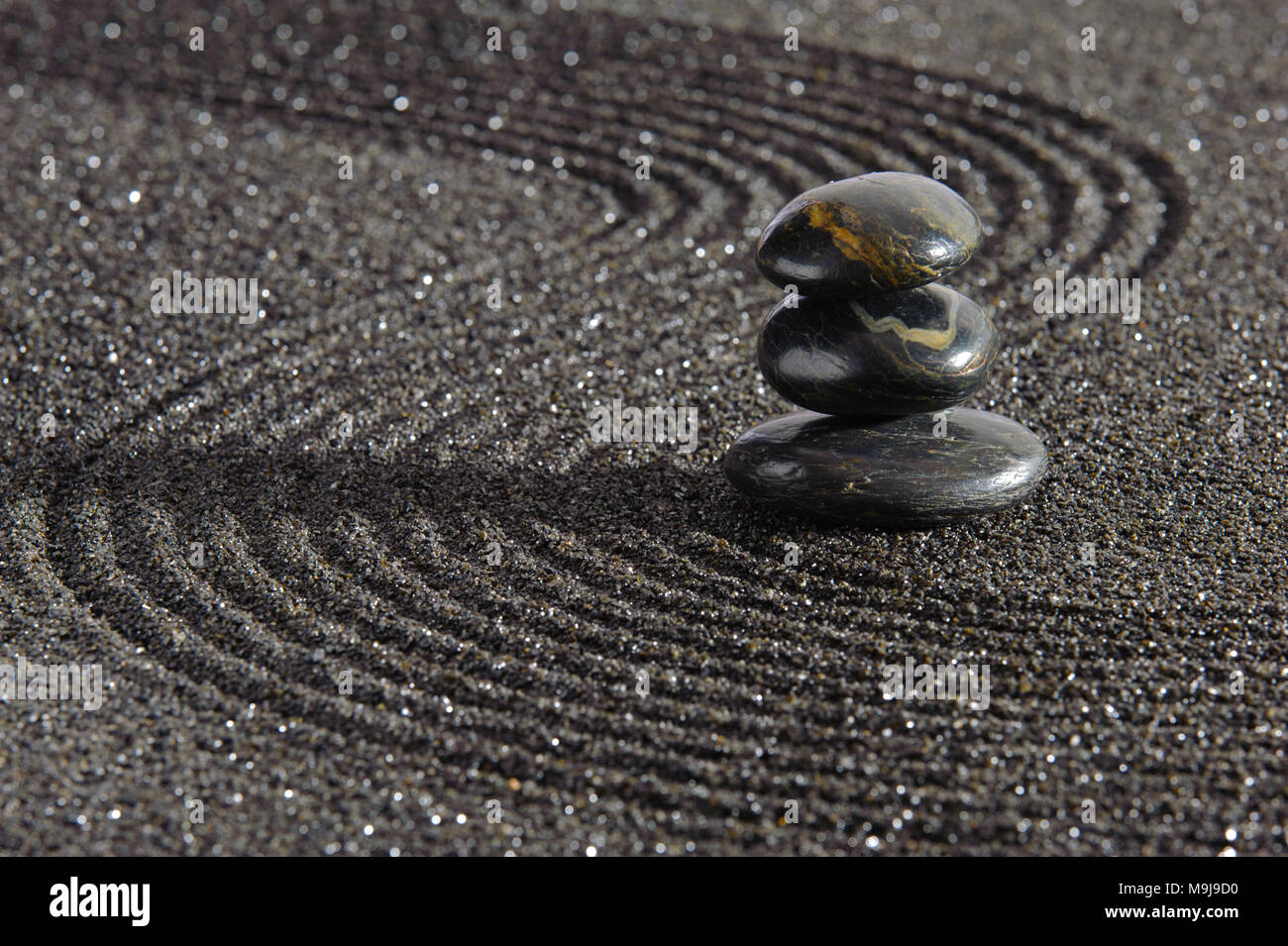 Japanese Zen garden with stacked stones in textured sand Stock Photo ...