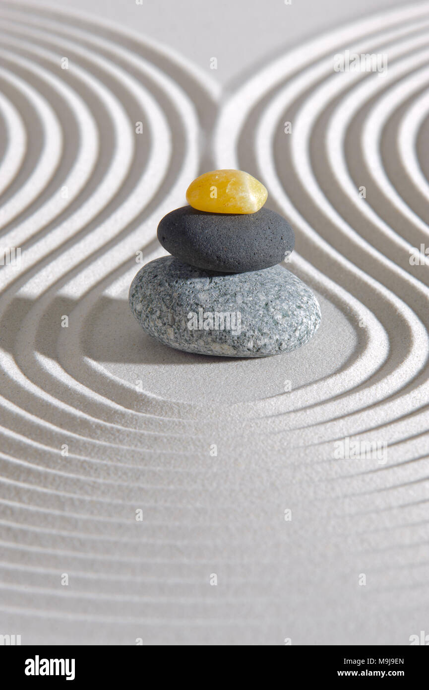 Japanese Zen garden with stacked stones in textured sand Stock Photo ...
