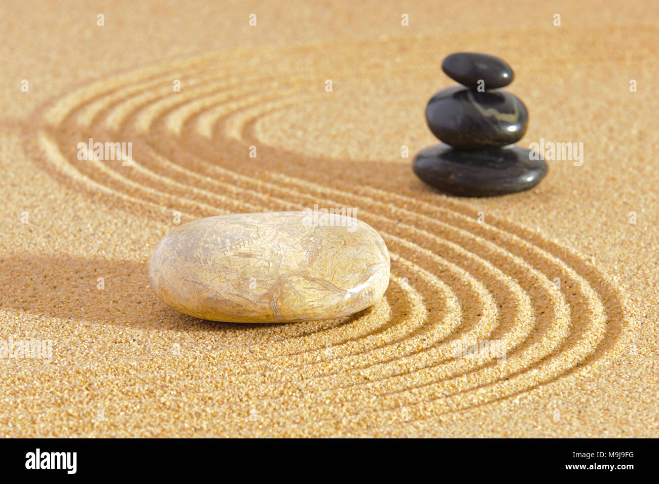 Japanese Zen garden with stacked stones in textured sand Stock Photo ...